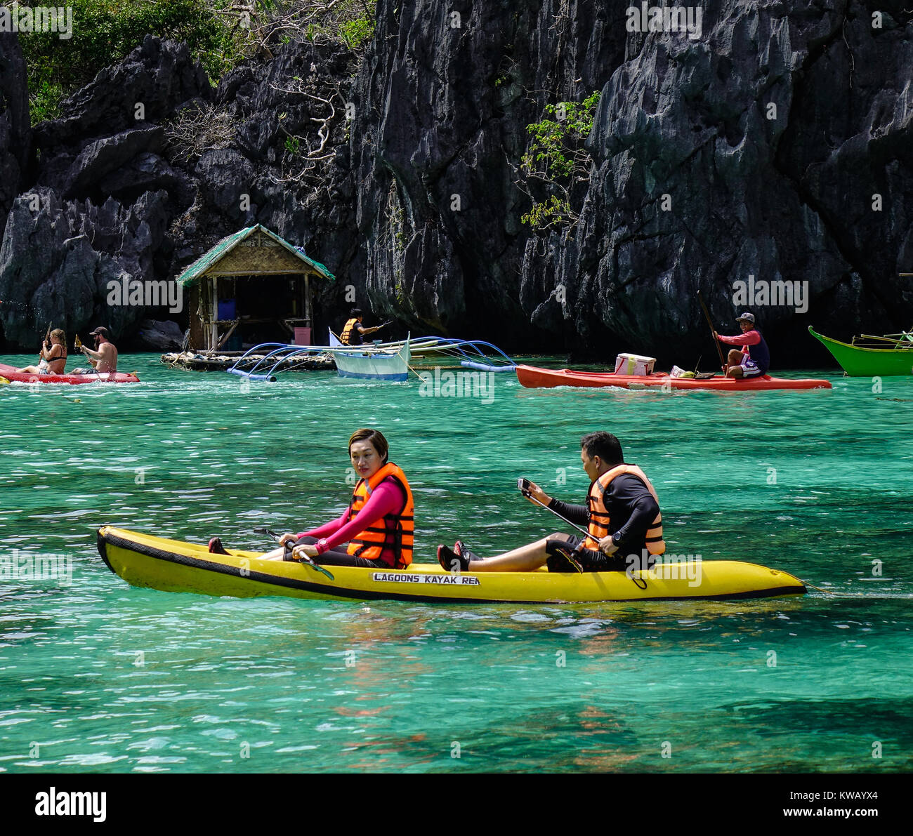 Palawan, Philippines - Apr 5, 2017. Tourists rowing kayaks at blue ...