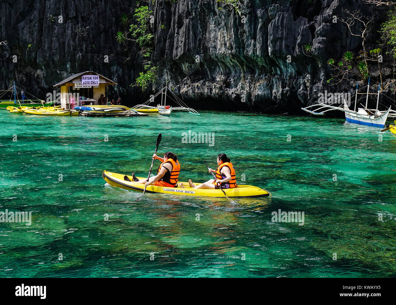 Palawan, Philippines - Apr 5, 2017. Tourists rowing kayaks at blue ...