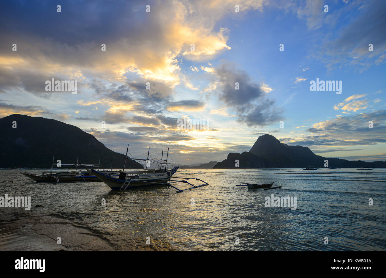 Sunset on the sea with boats in Palawan, Philippines. Palawan is one of ...