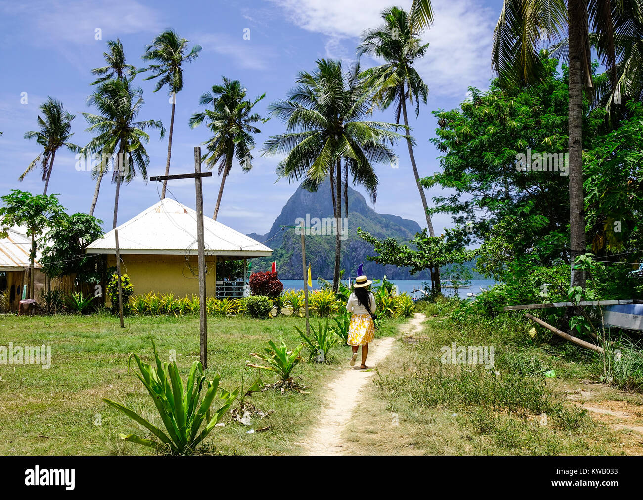 A woman walking on rural road in Palawan, Philippines. Palawan is one ...