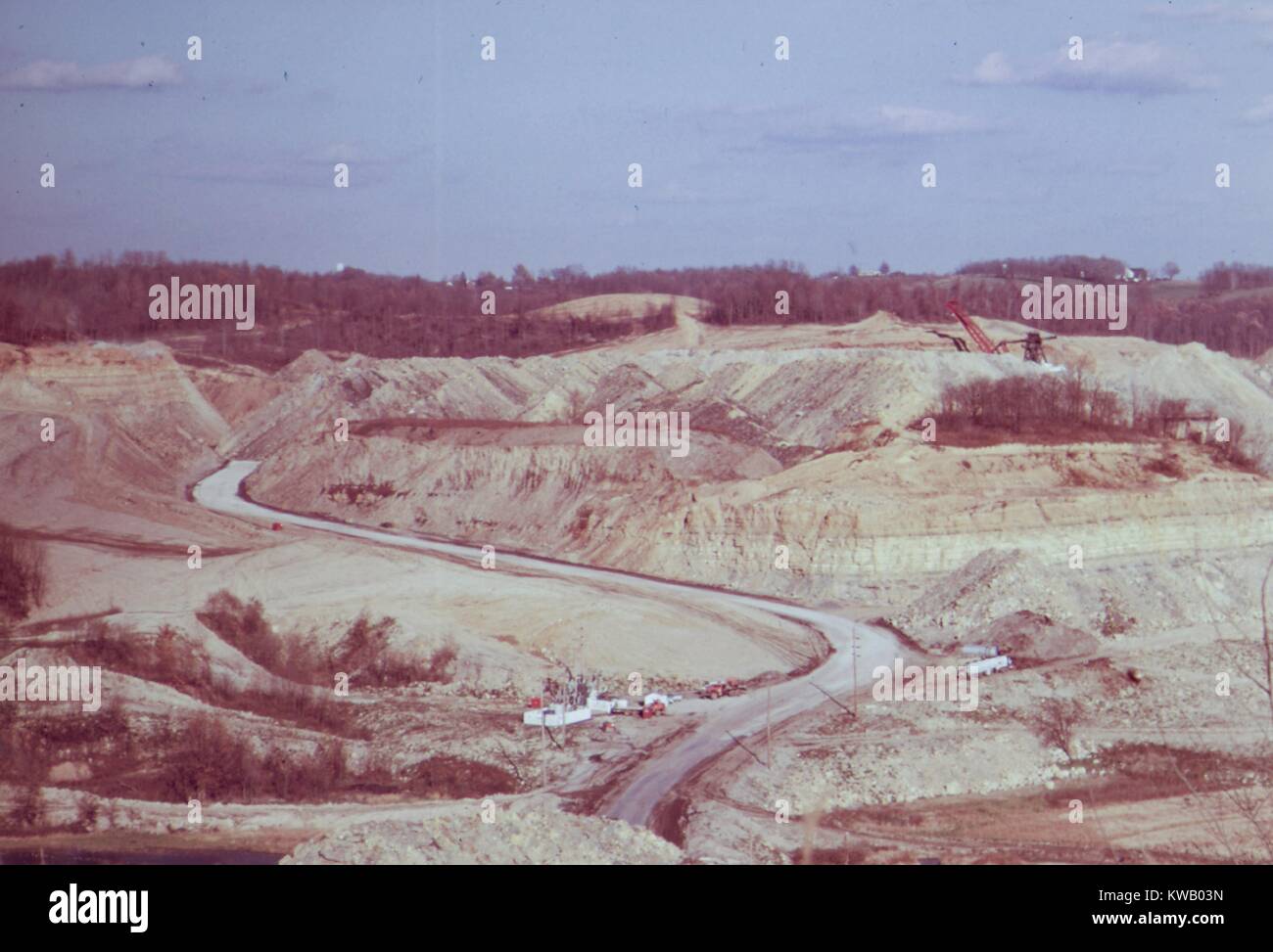 Winding country road crossing a hilly barren landscape devastated by ...