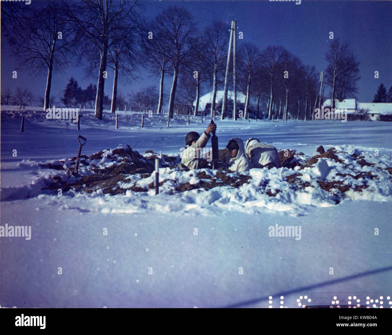 World War II, Three American soldiers in the snowy field on a sunny day ...