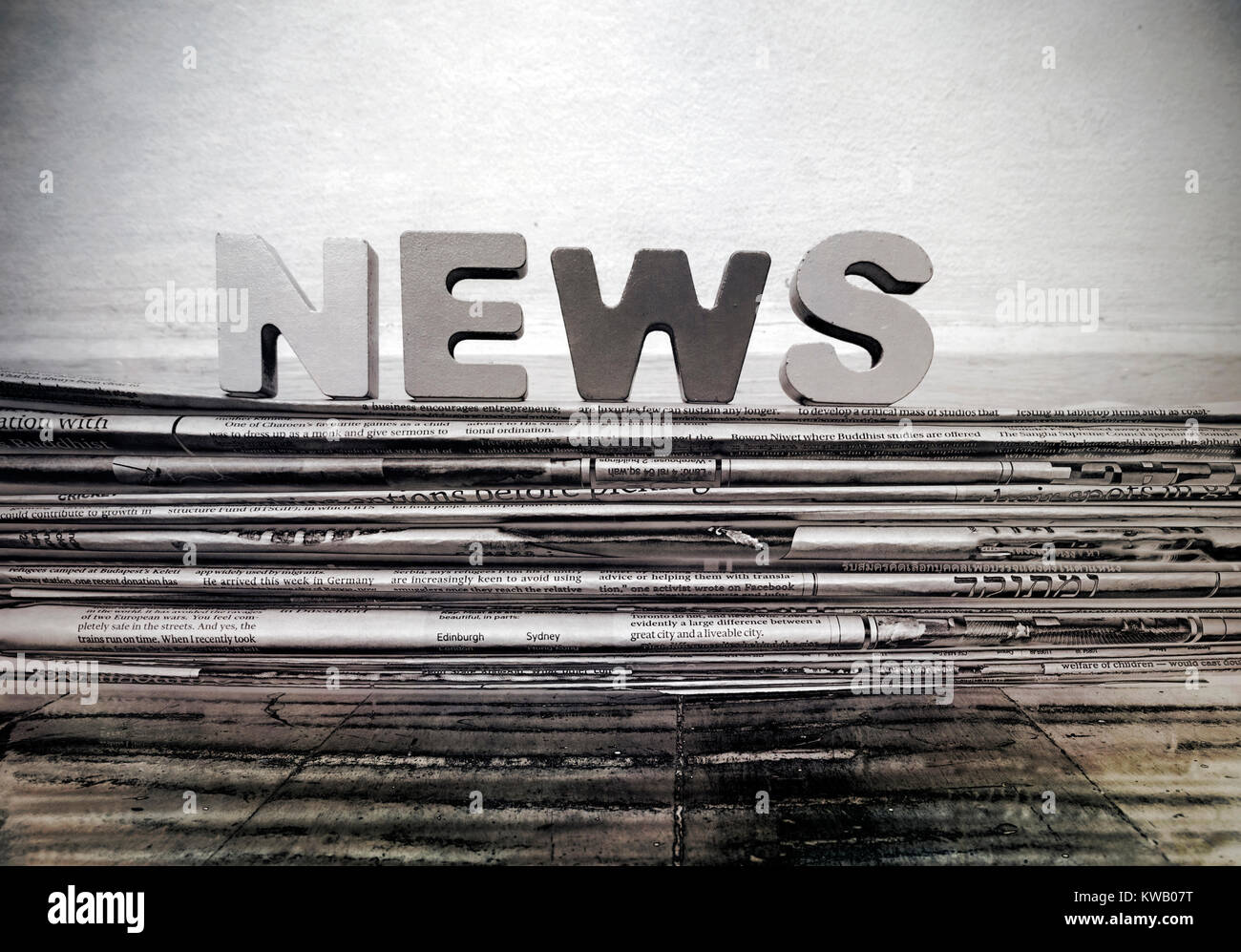 the word NEWS with wooden letters on a ple of old nespaper Stock Photo ...