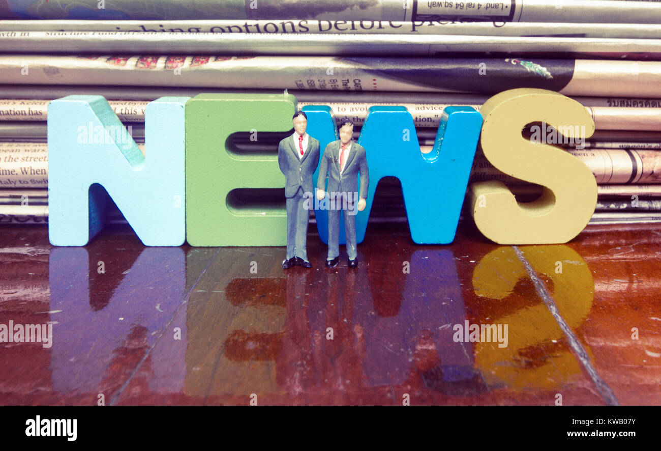 the word NEWS with wooden letters on a ple of old nespaper Stock Photo ...