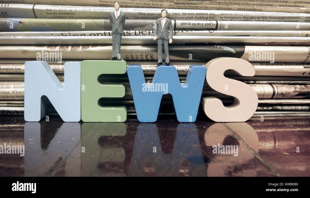 the word NEWS with wooden letters on a ple of old nespaper Stock Photo ...