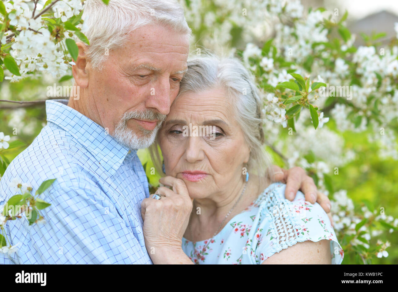 Sad senior couple in spring park Stock Photo - Alamy