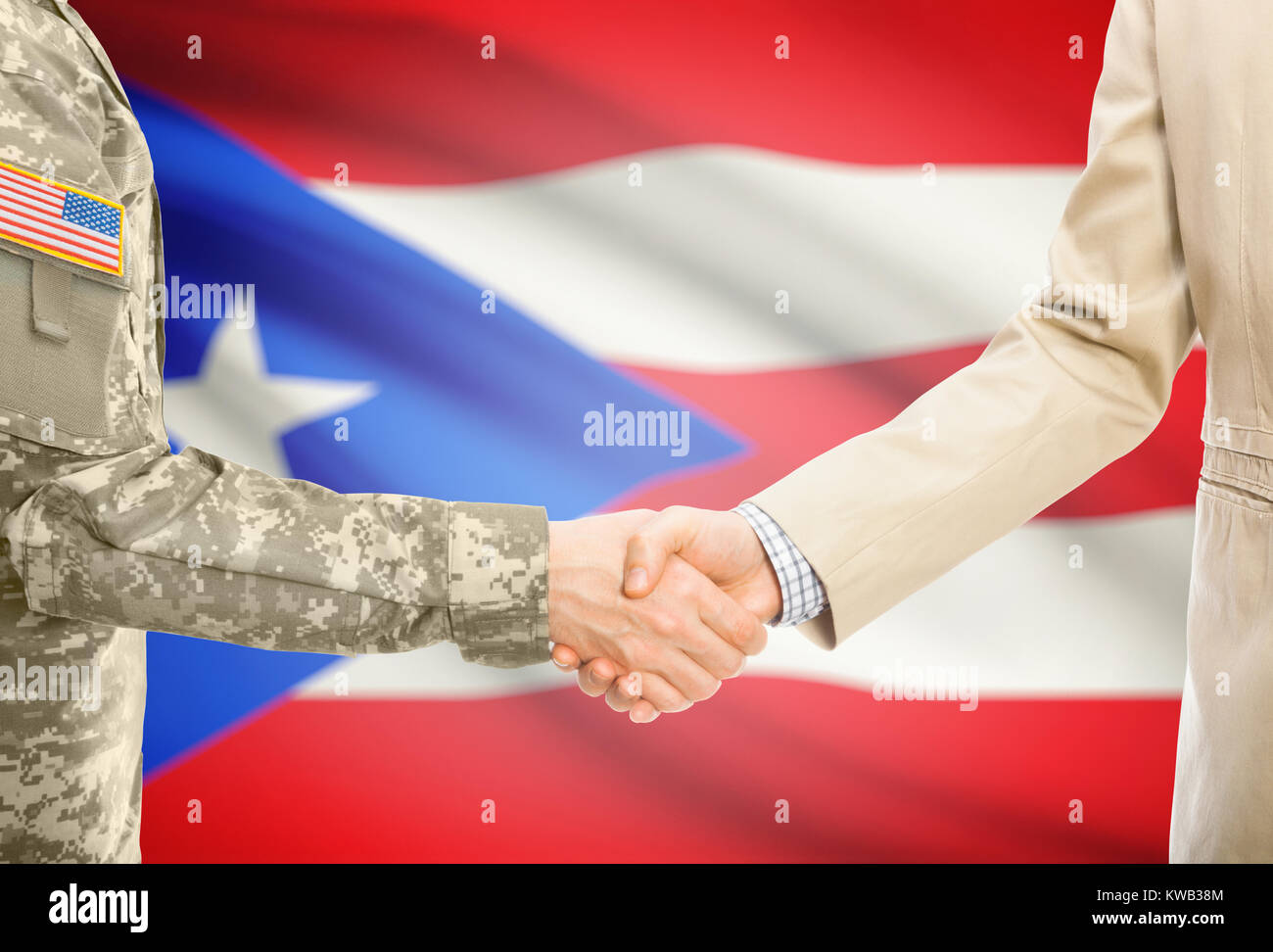 American soldier in uniform and civil man in suit shaking hands with ...