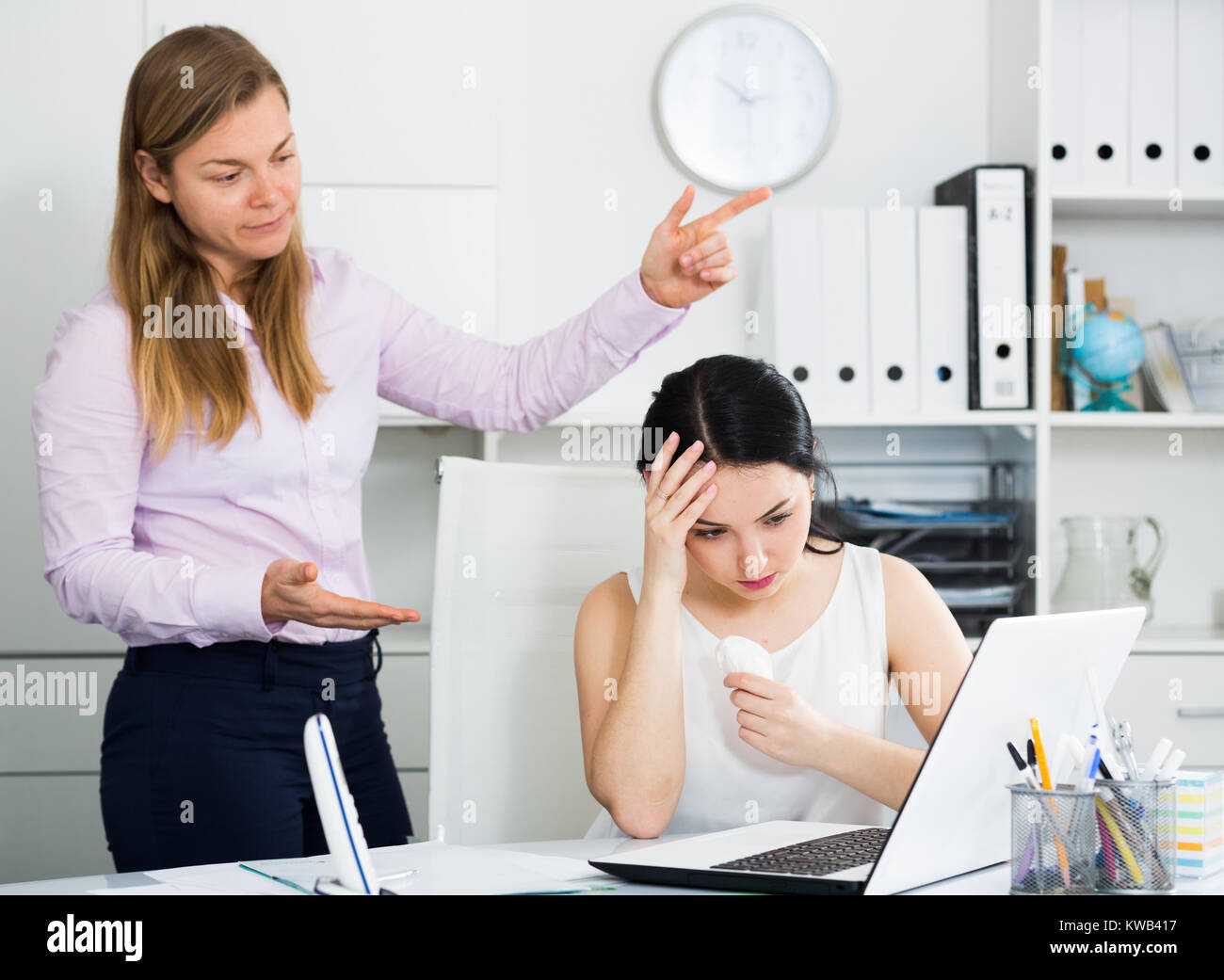 Female senior manager telling off her co-worker during working day ...