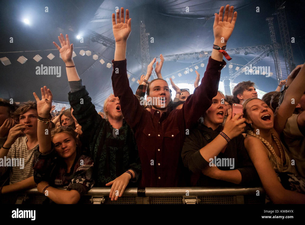 Energetic hip hop and rap fans have a great time front row at a concert ...