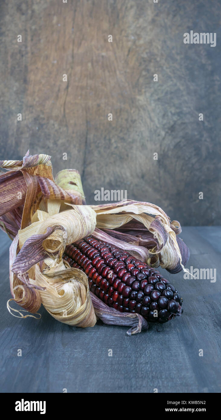 fresh organic purple corn cob with leaves on a wooden background Stock ...