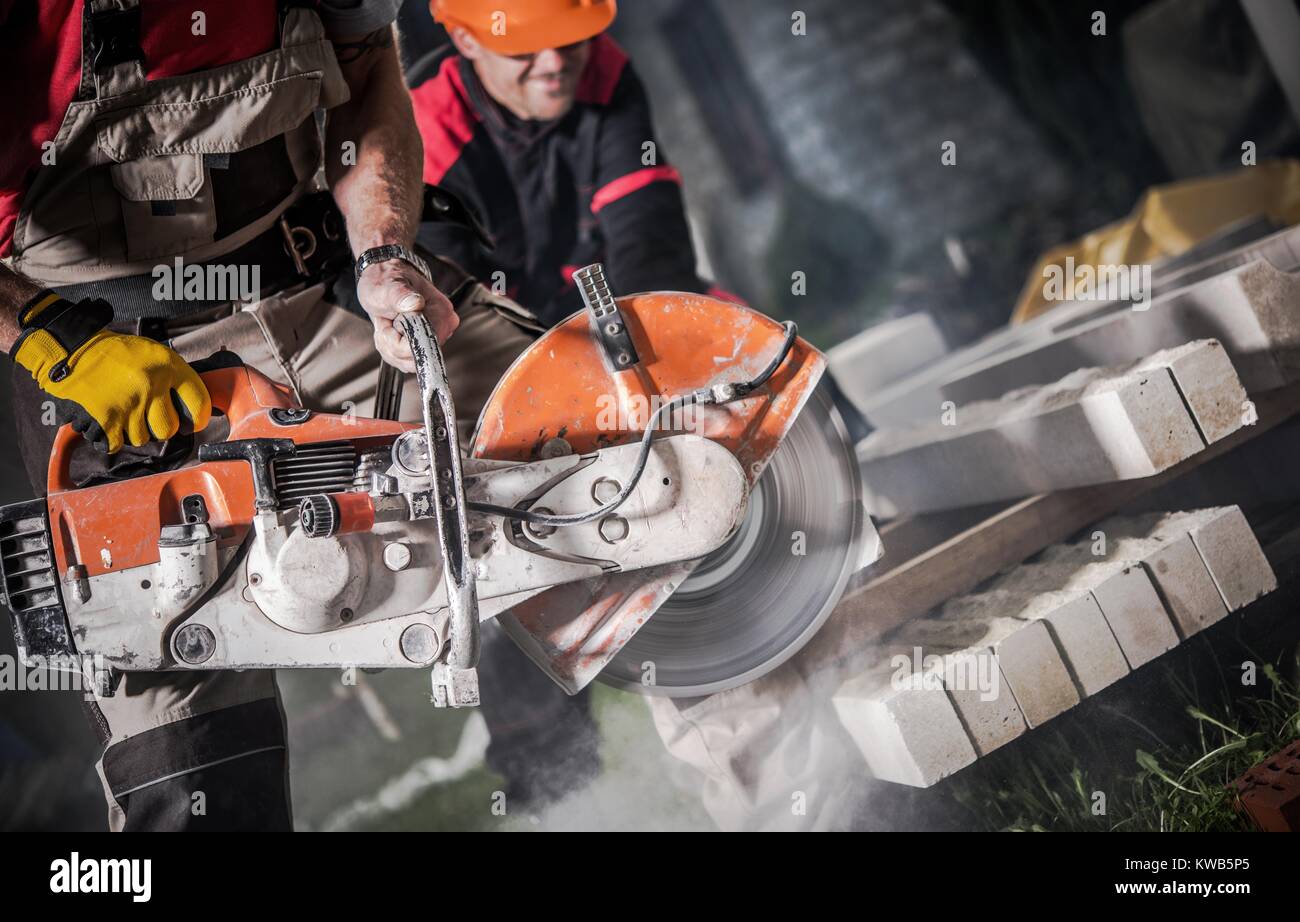 Construction Site Works. Caucasian Workers Cutting Concrete Elements ...