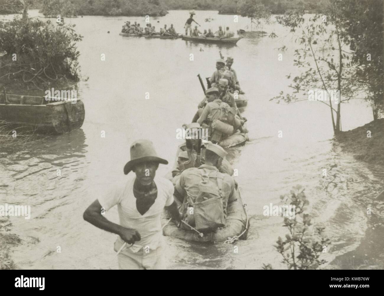 British Indian Army crossing a river in collapsible rubber boats in ...
