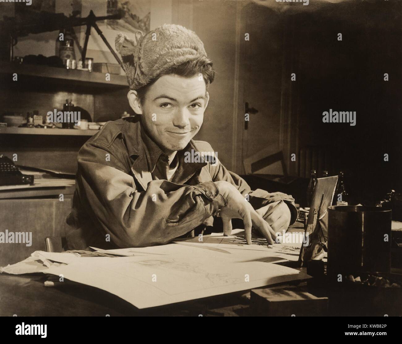 Soldier-Cartoonist Bill Mauldin seated at desk in office in Il ...
