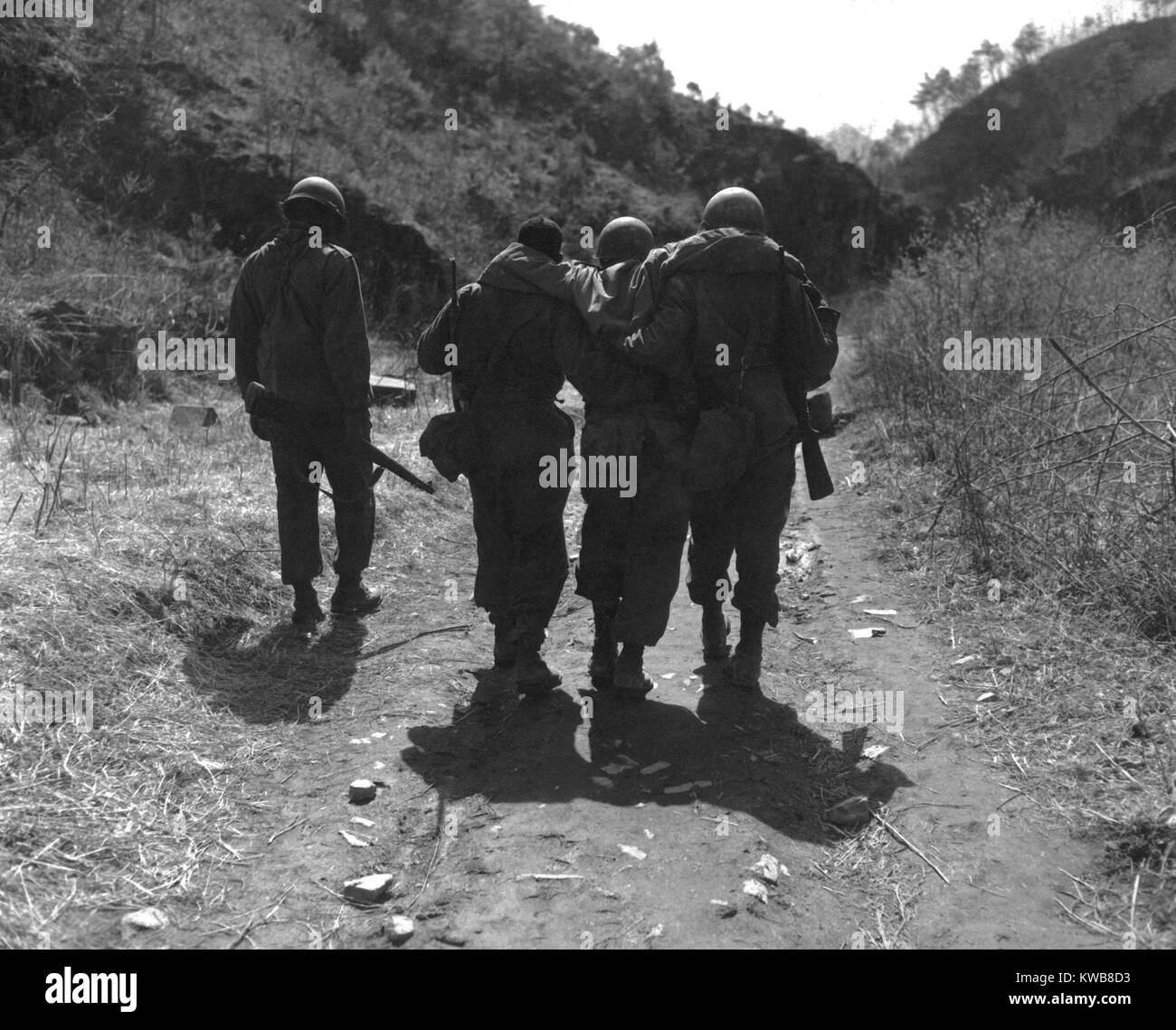 U.S. soldiers aid wounded man of 24th Infantry Regiment. Following a ...