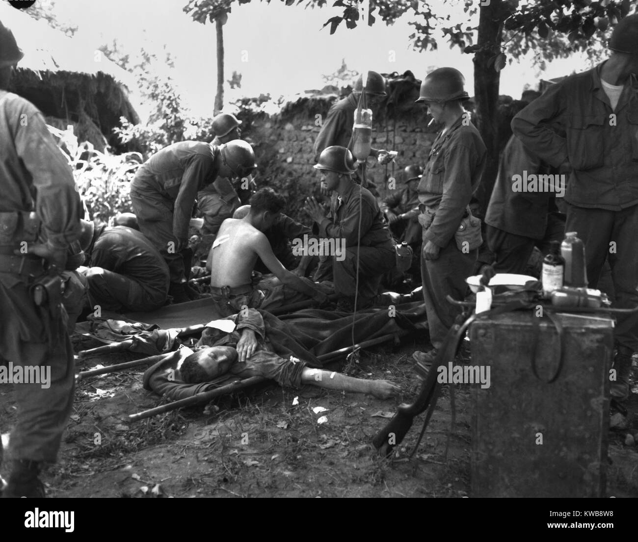 U.S. soldiers receive medical treatment at a first aid station near ...