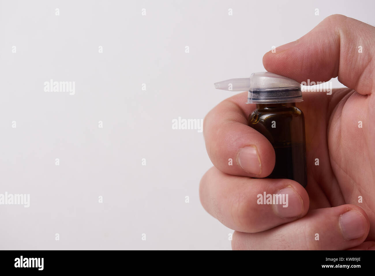 Eye liquid bottle in human hand close-up on white background Stock ...