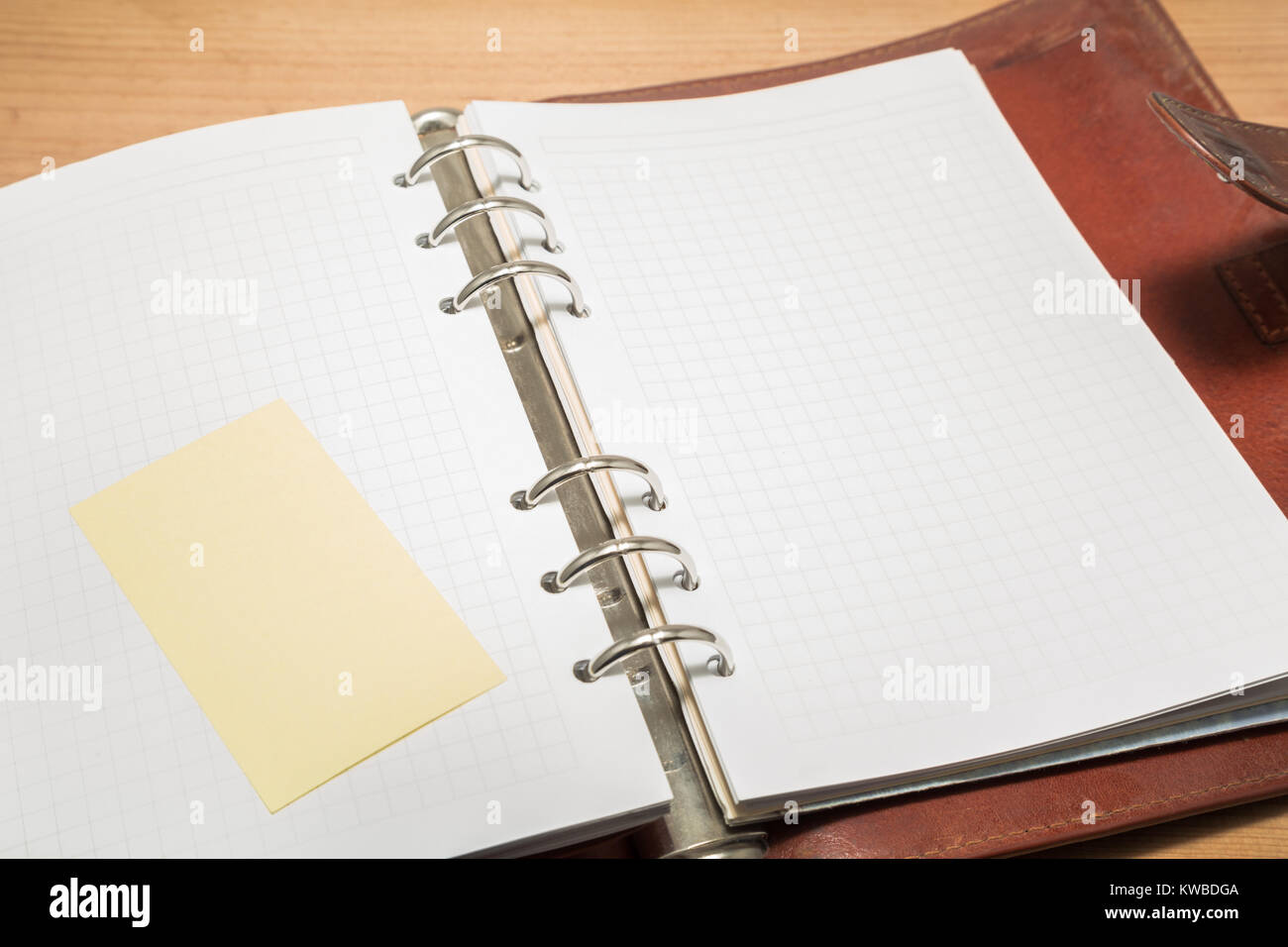 Binder of leather open on the table, with blank sheets for writting ...
