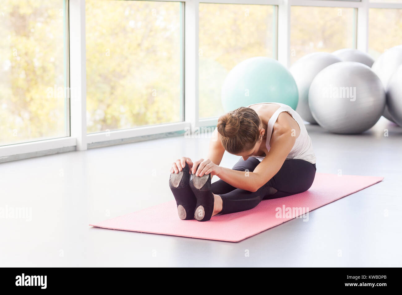 Balāsana. Seated forward bend. Child’s Pose. Woman doing tilt. Studio ...