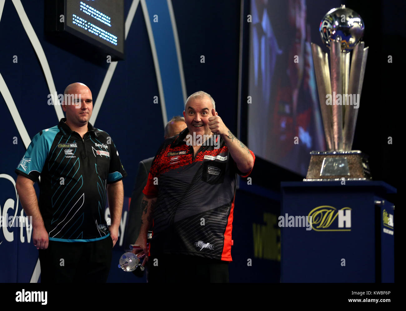 Phil Taylor with his runner's up trophy after loosing to Rob Cross ...