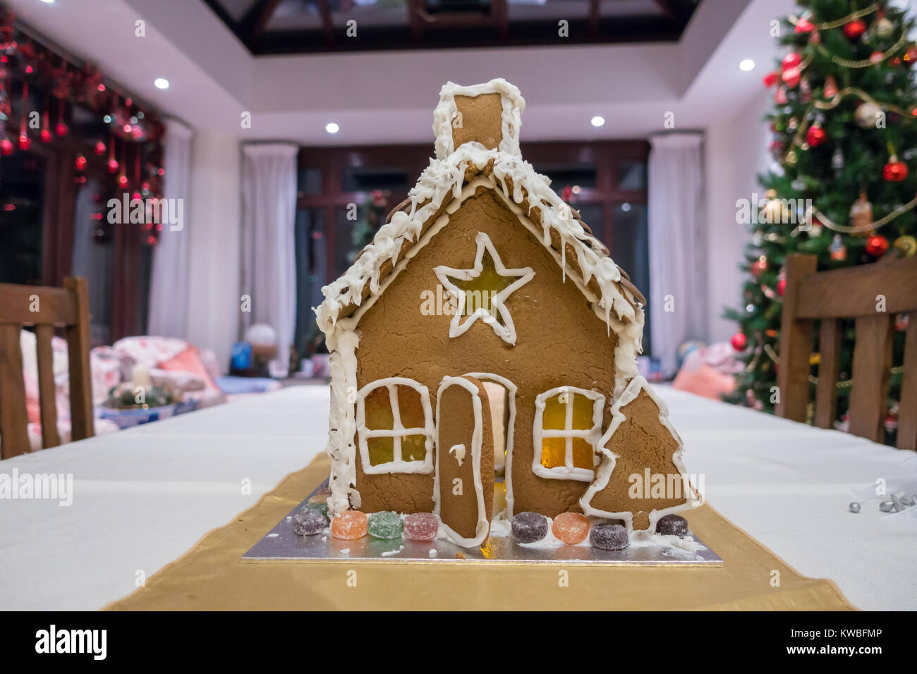 A gingerbread house takes pride of place standing in the middle of a ...