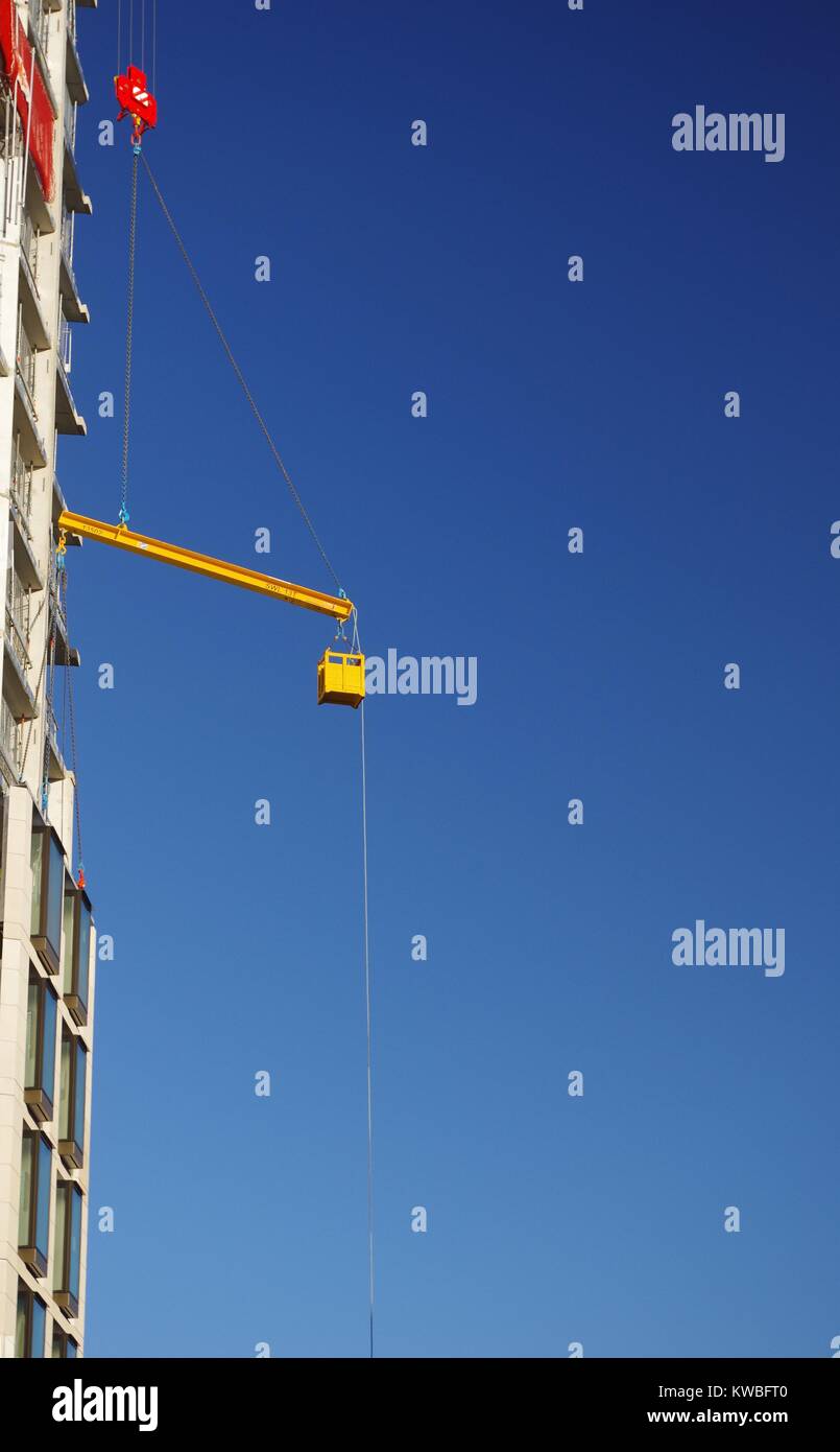 Yellow Suspended Steel Beam being Hoisted by a Crane against a Blue Sky ...