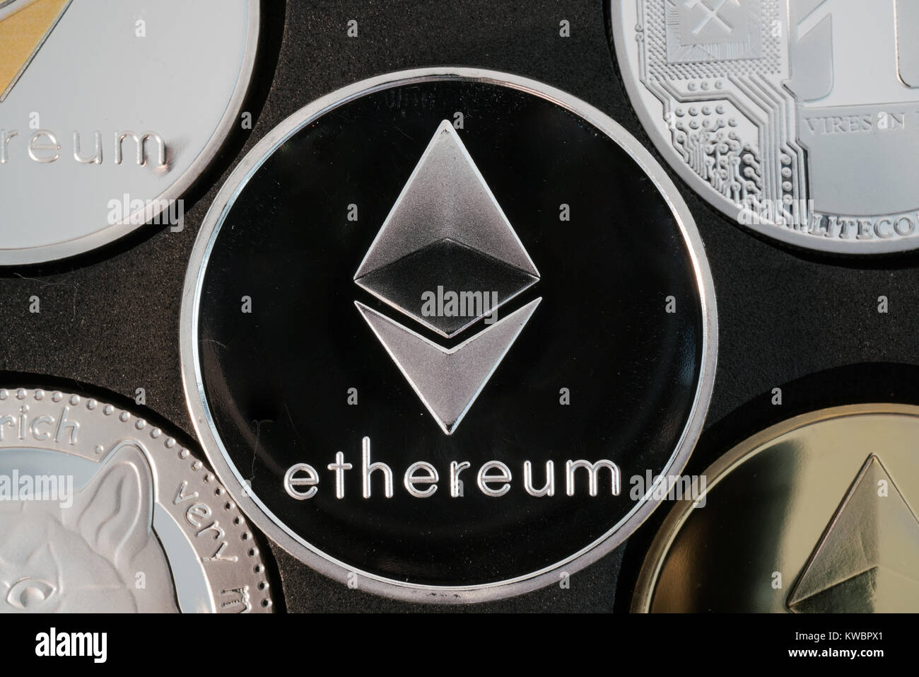 Ethereum cryptocurrency real silver coin in middle of other crypto ...