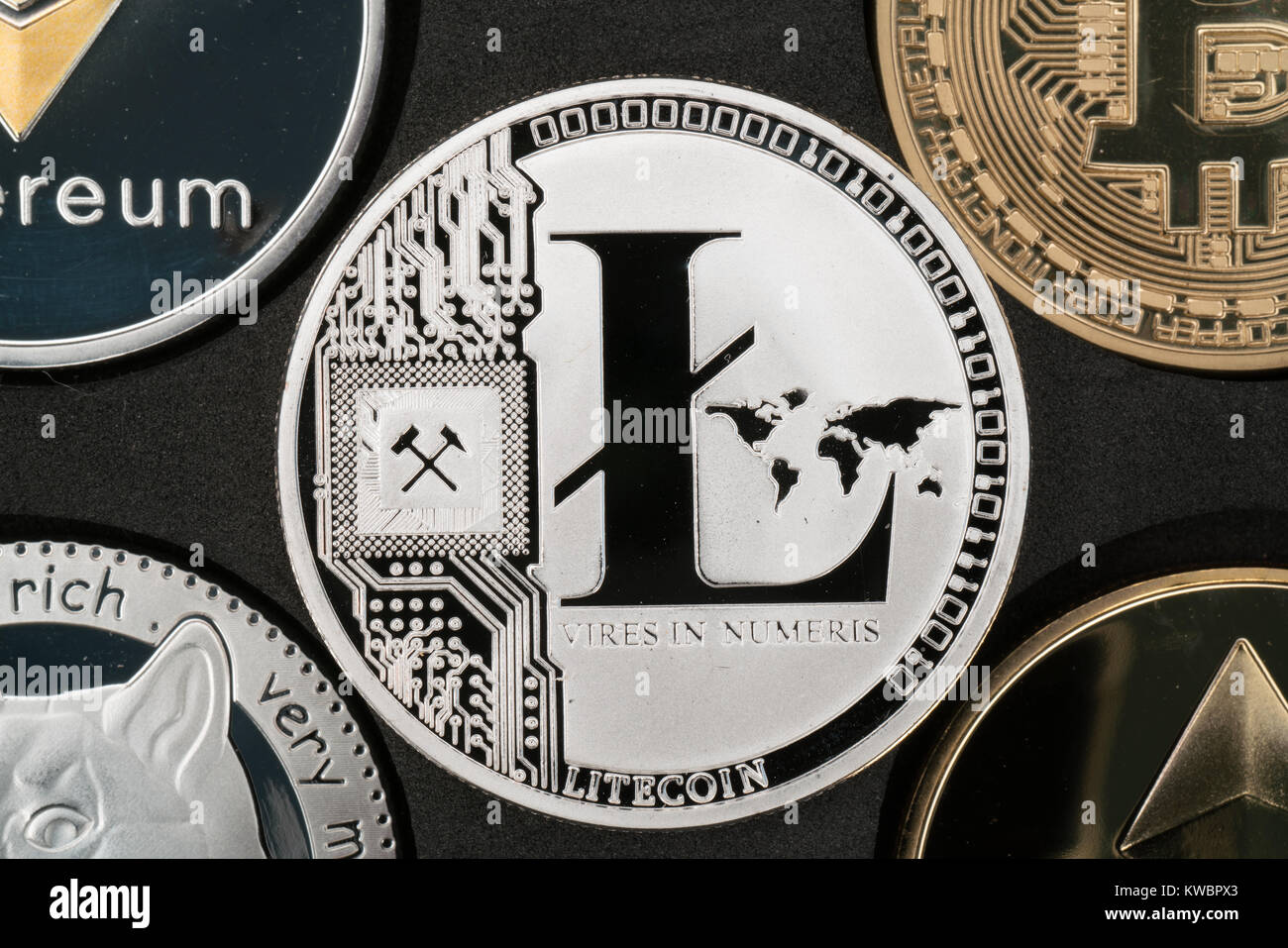 Litecoin cryptocurrency real silver coin in middle of other crypto ...