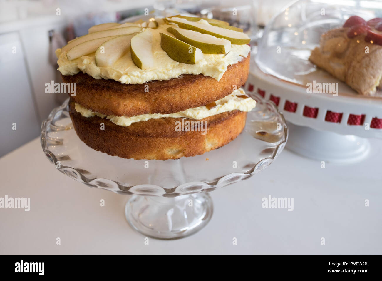 Homemade sponge cake with spiced pear topping on stand Stock Photo - Alamy