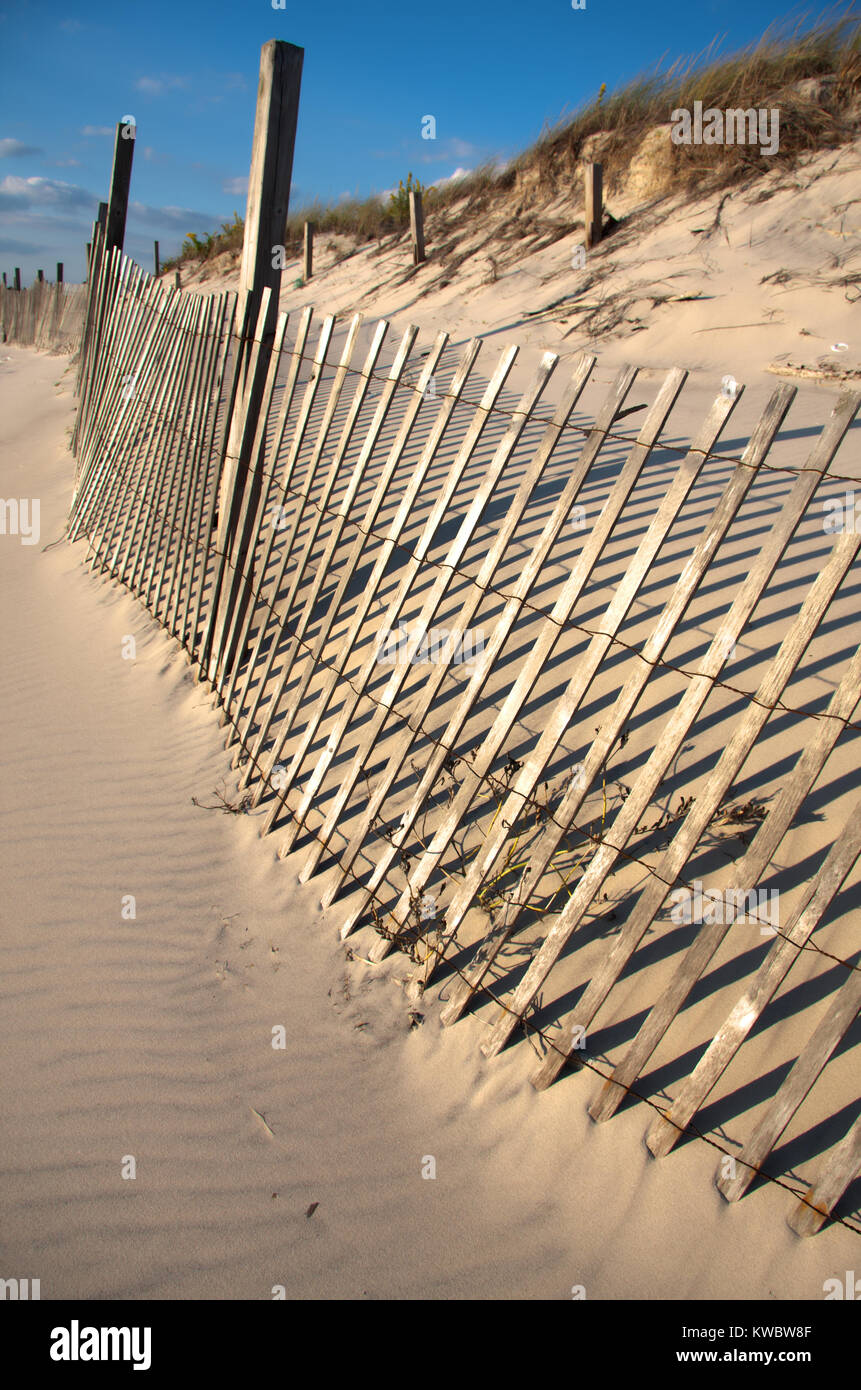 Fence Sandy beach. Cloudy sky Stock Photo - Alamy