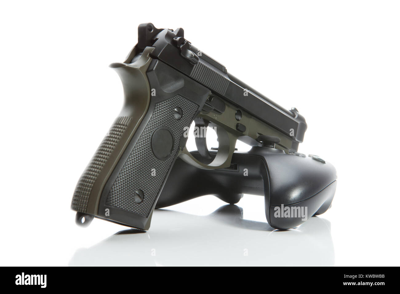 Real and virtual life concept - a game controller under a real handgun ...