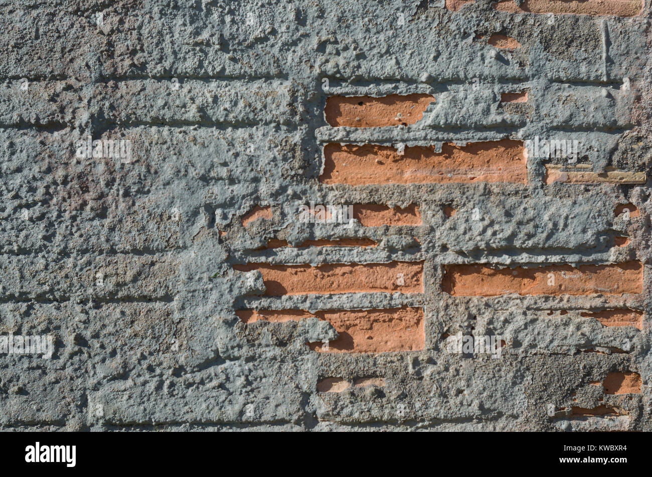 Wall with falling plaster and clay brick appearing, constructive defect ...