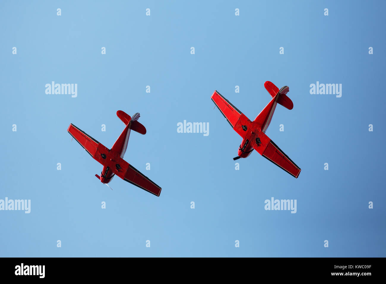 Two red airplanes in blue sky Stock Photo - Alamy