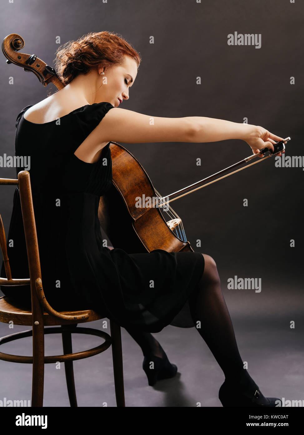 Photo of a beautiful woman playing a cello Stock Photo - Alamy