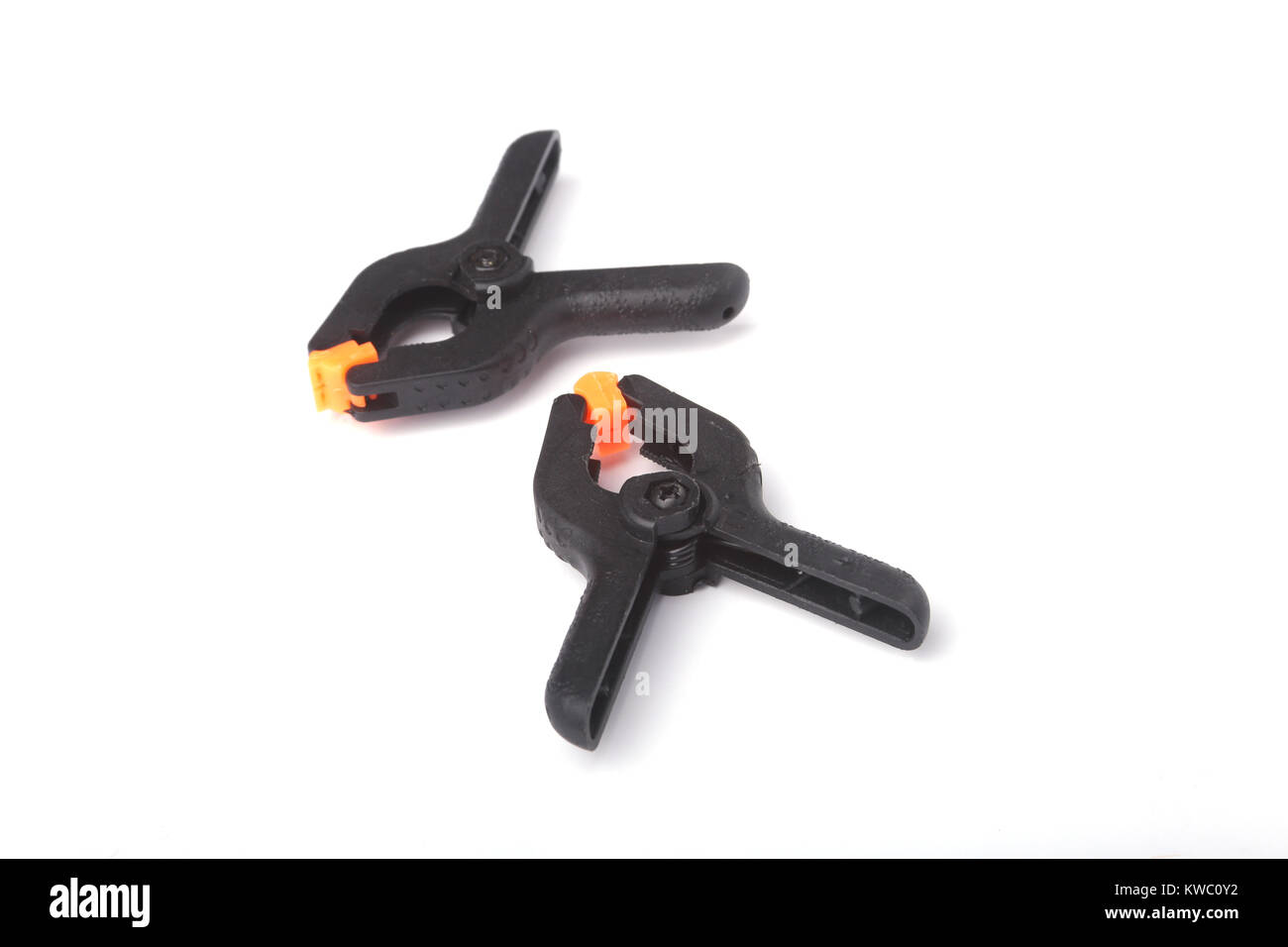 Black plastic spring clamp isolated on white background Stock Photo - Alamy