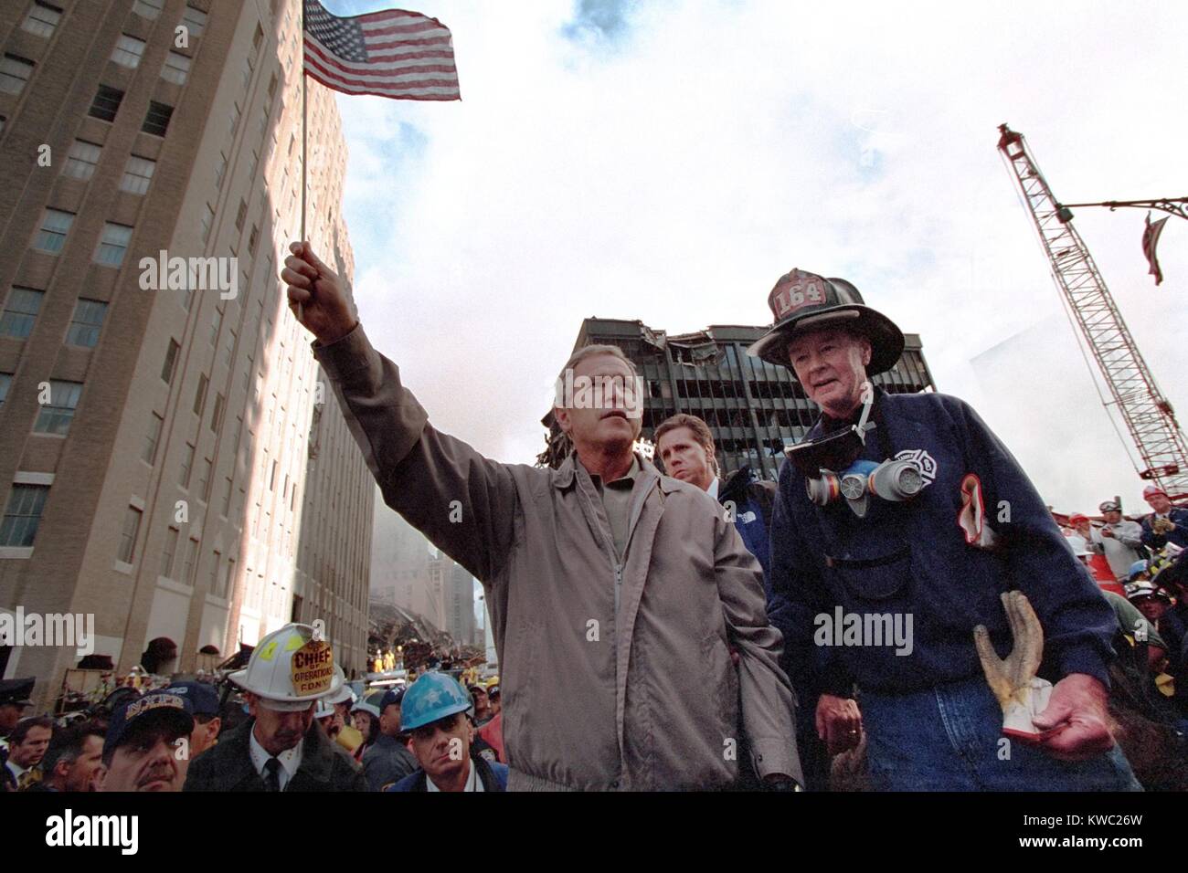President George W. Bush waves an American flag after addressing ...