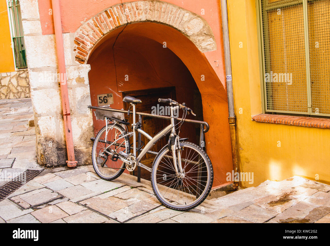 An old Bike in a French Archway Stock Photo - Alamy