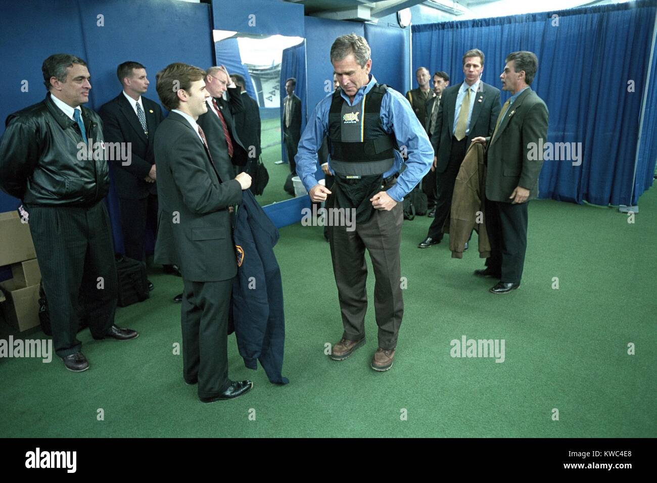 President George W. Bush puts on a vest before the first pitch in Game ...