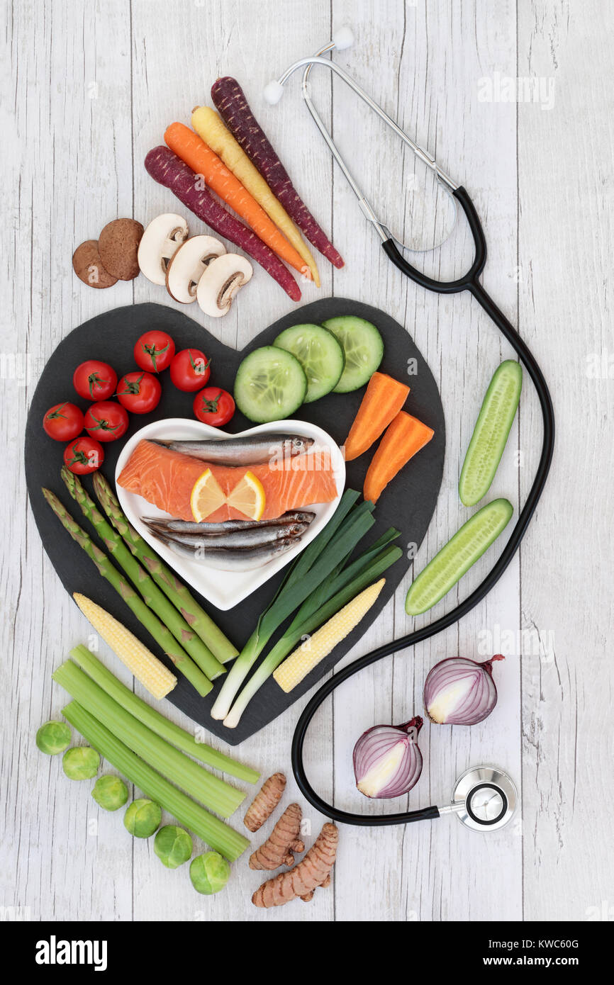 Health heart food for fitness concept with fresh fish and vegetables on ...