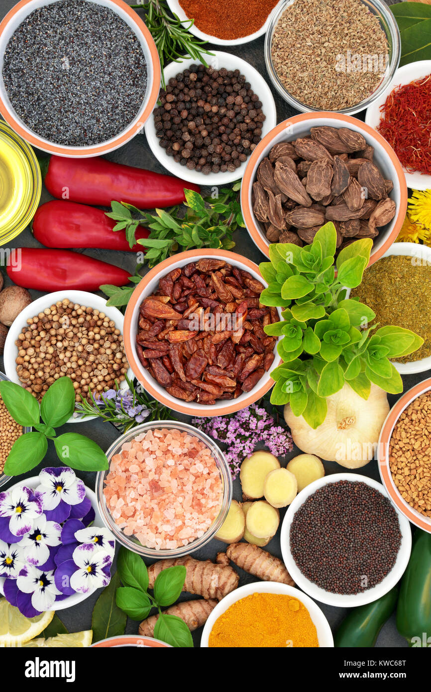 Herb spice and edible flower selection in bowls and loose forming an ...