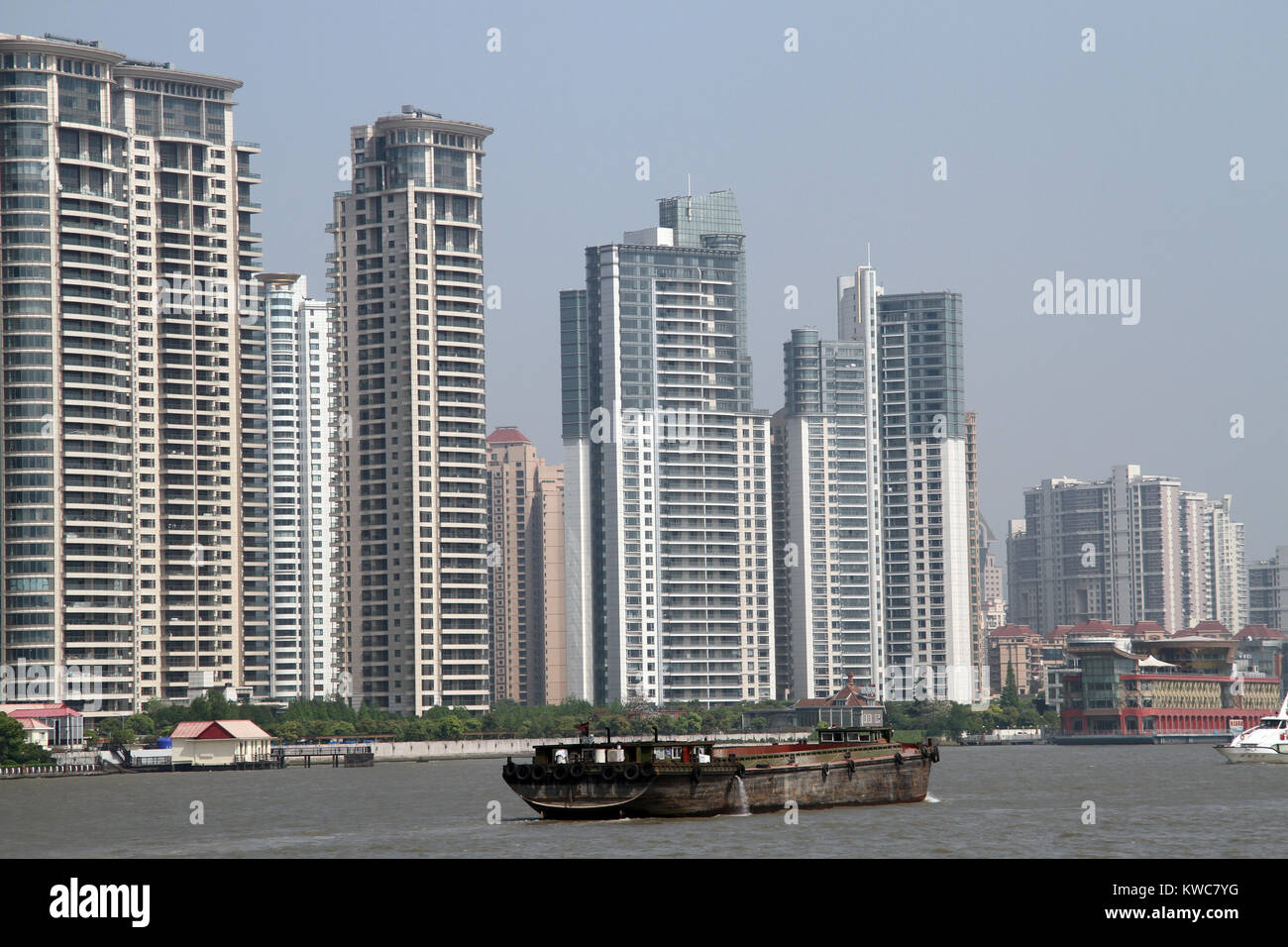 Cargo ship on the river Huangpu and new buildings in Shanghai, China ...
