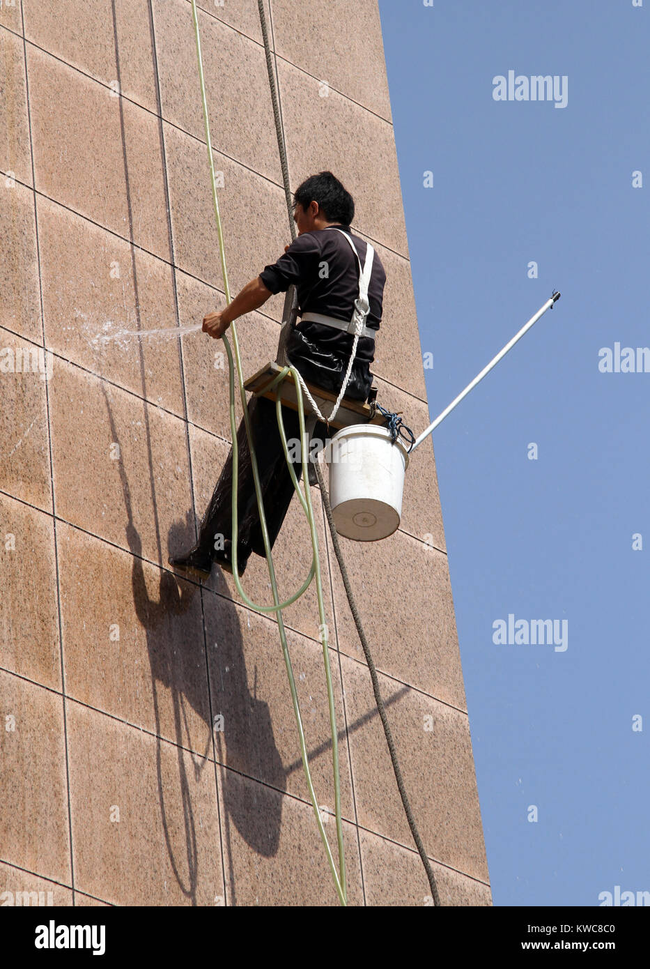 Cleaner on the wall of building Stock Photo - Alamy