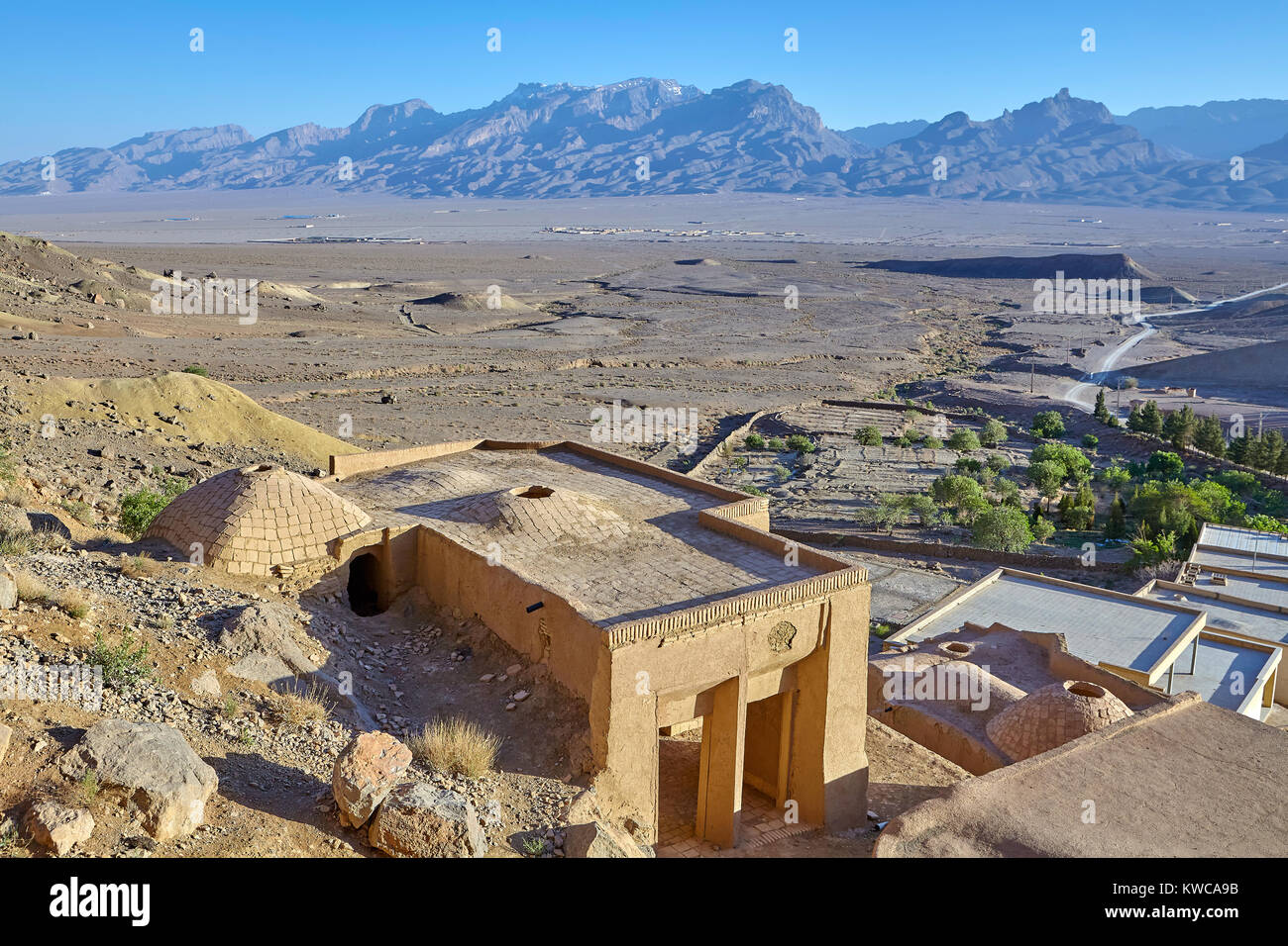 An ancient limestone building in a hilly area around the Iranian town ...