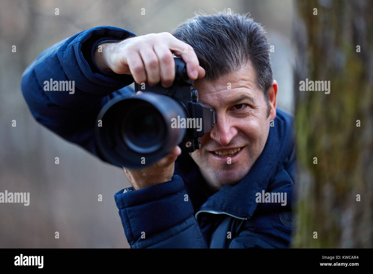 Photographer with professional camera taking pictures outdoor Stock ...