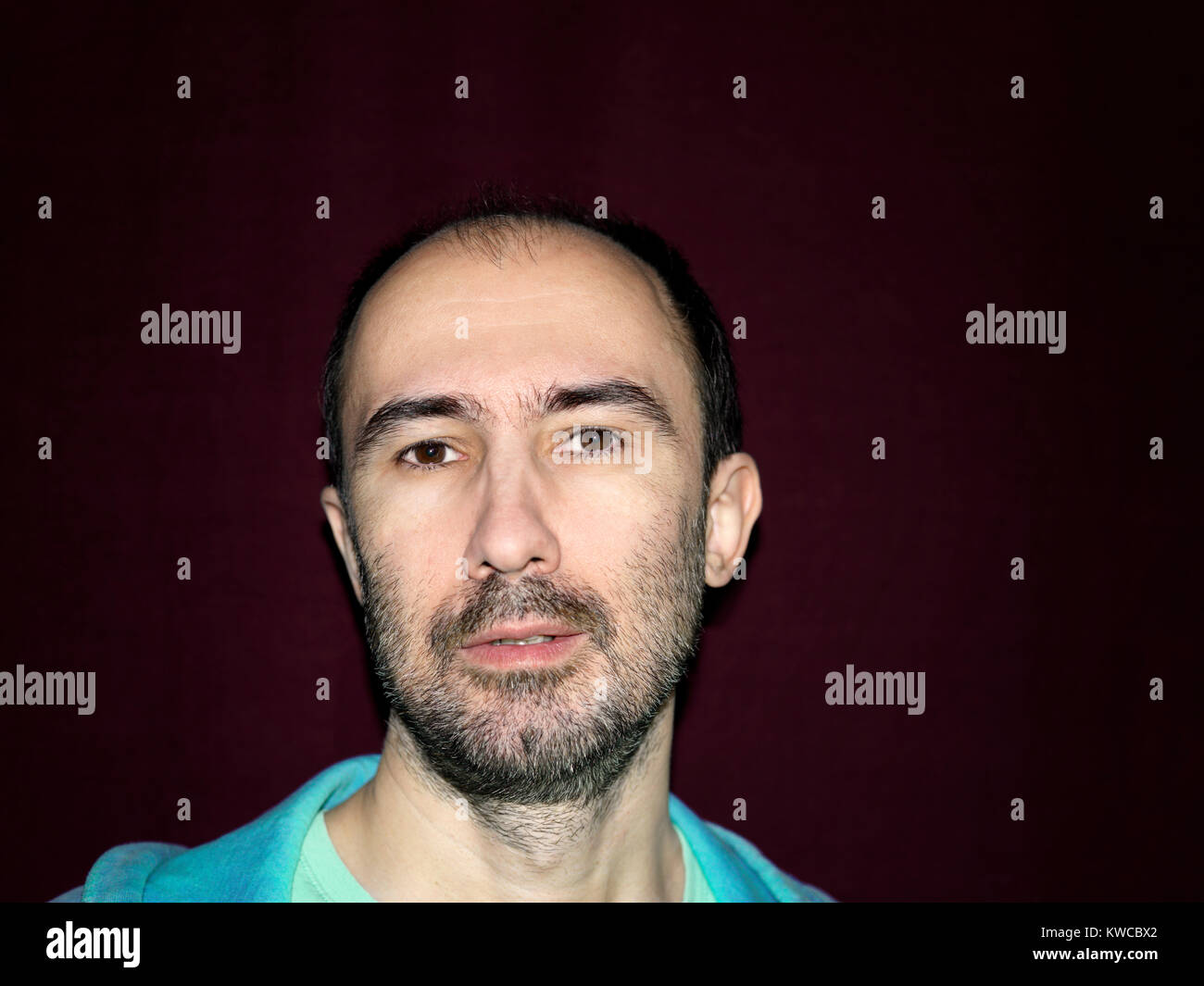 Studio portrait of a guy with mocking look on his unshaven face Stock ...