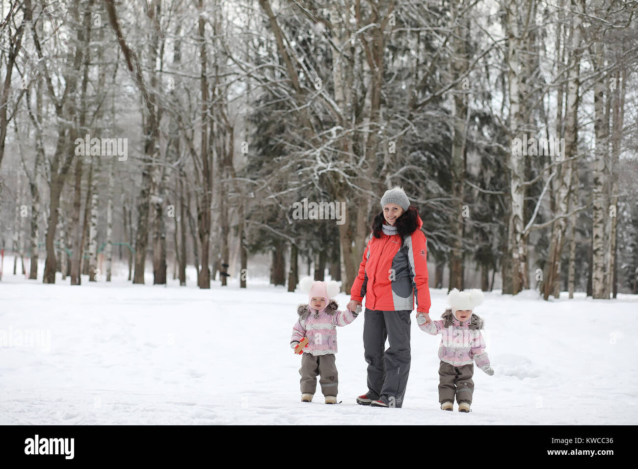 Children walk in the park in winter. Winter forest family with children ...