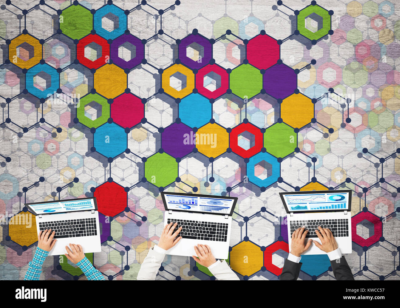 Group of three people with devices in hands working together as symbol ...