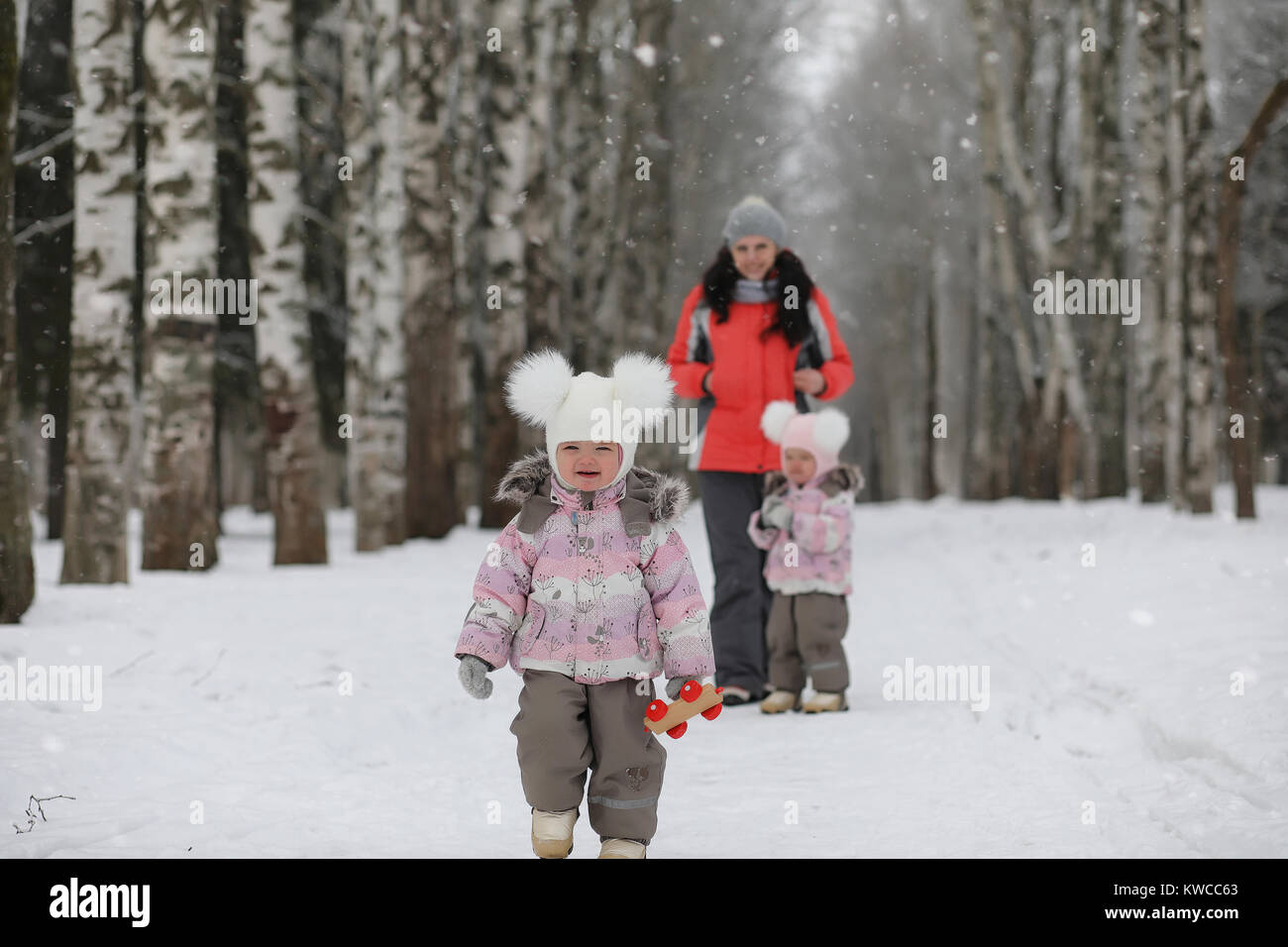 Children walk in the park in winter. Winter forest family with children ...