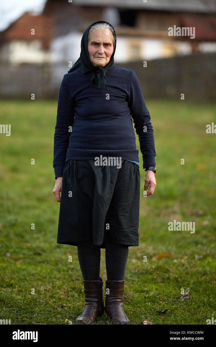 Old woman in black outdoor in the countryside Stock Photo - Alamy