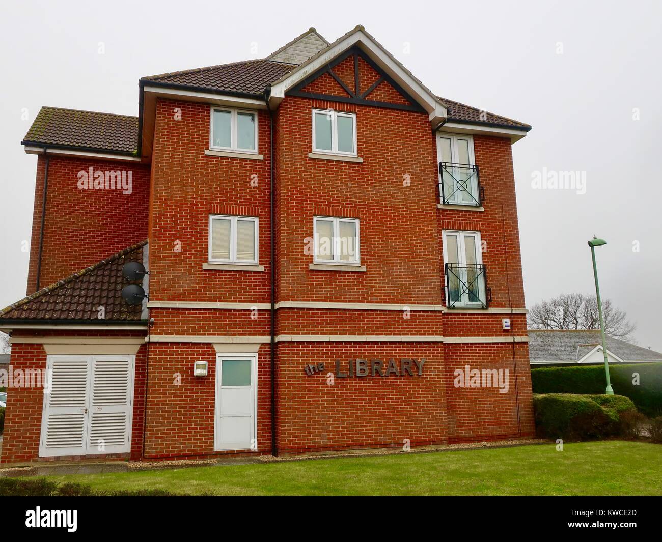 The Library with flats above. A modern red brick building. Grange Farm ...
