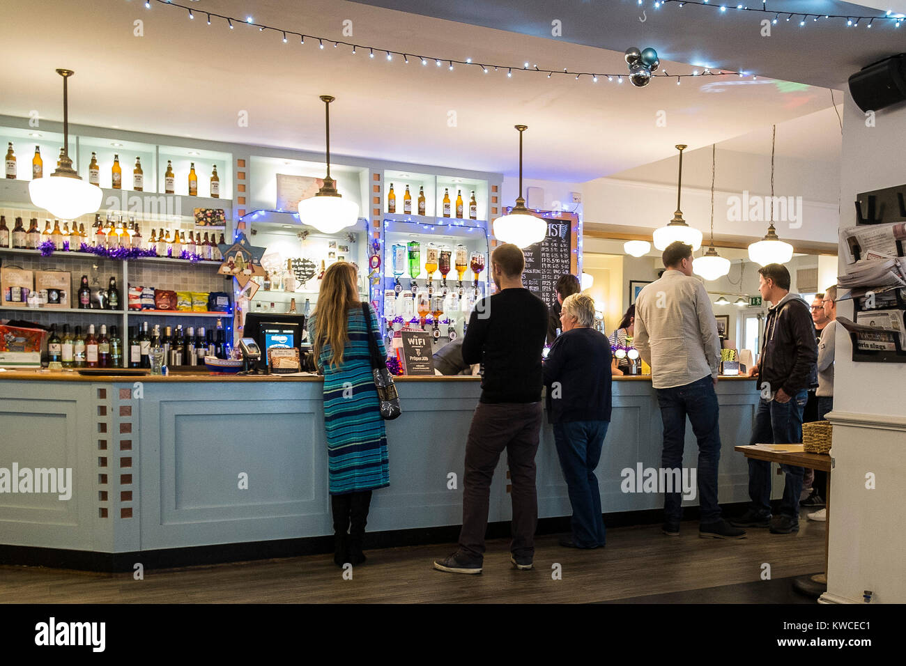 Pub interior - Customers standing at a bar waiting to be served Stock ...